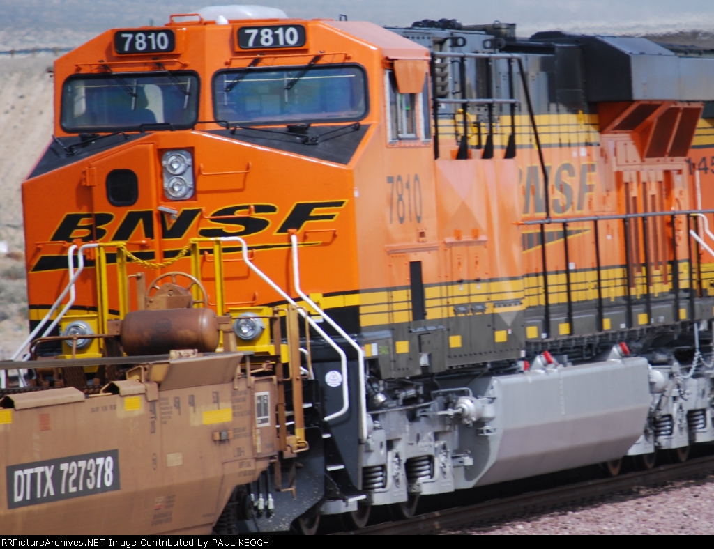 Zoom in shot of a Very Brand New ES44DC BNSF 7810 as she rolls east towards the BNSF Barstow ...